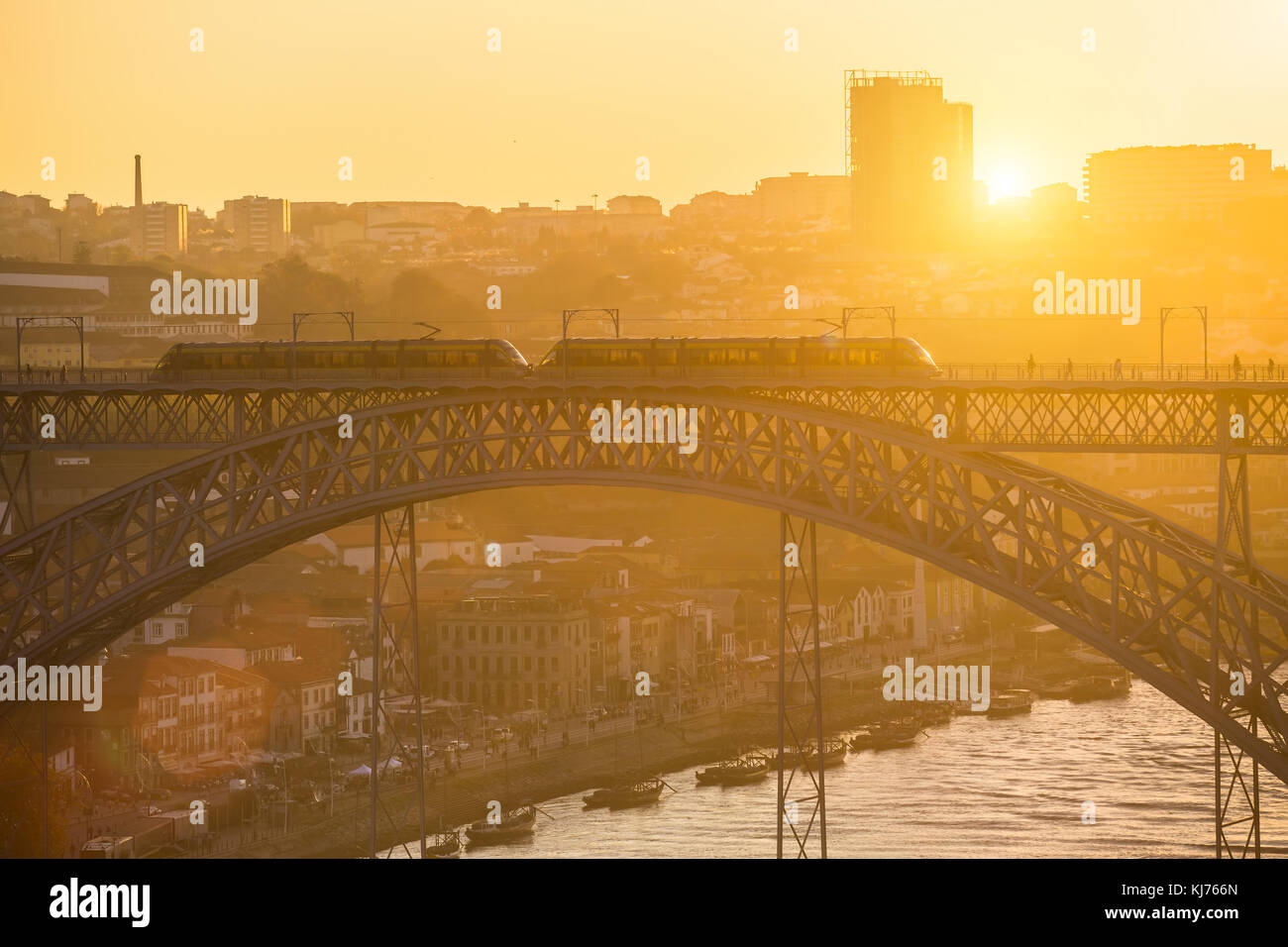 Dom Luis I bridge over Douro river in the golden light of the setting ...