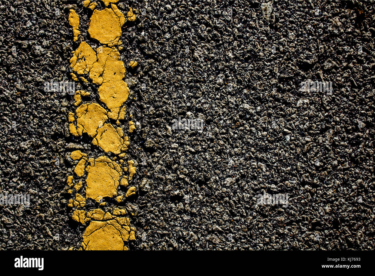 The Yellow line crack on the road Stock Photo - Alamy