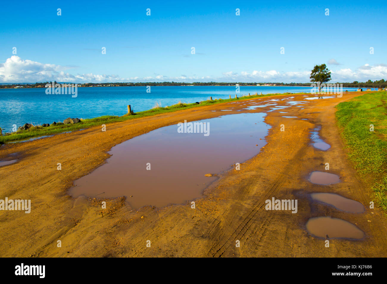 Muddy puddles near calm waters of the Leschenault Estuary near ...