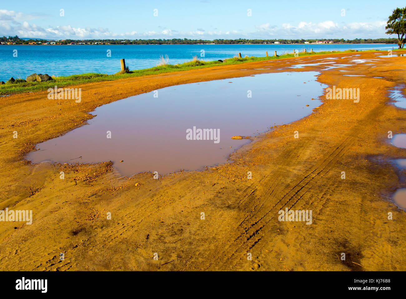 Muddy puddles near calm waters of the Leschenault Estuary near ...