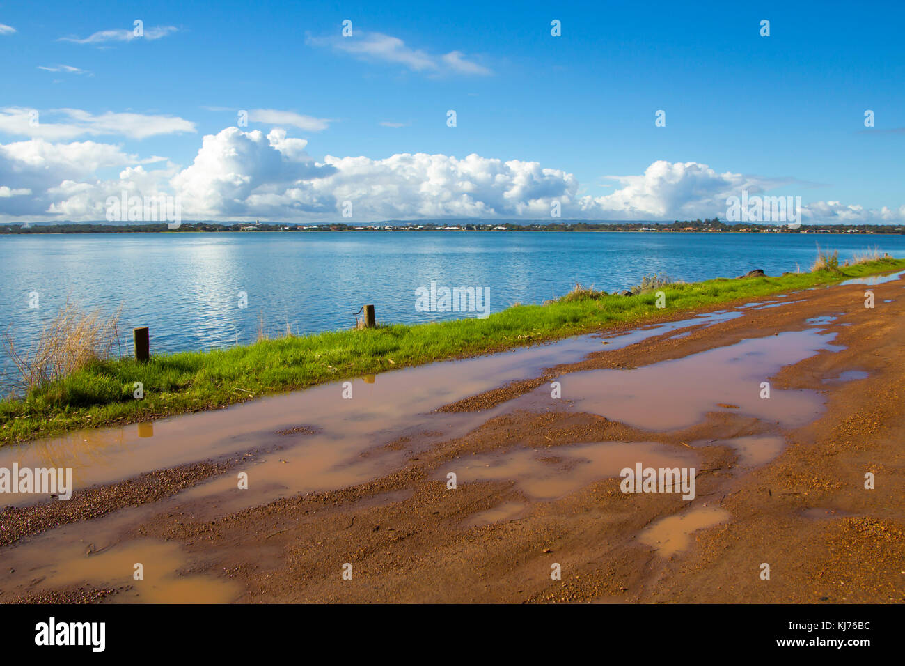 Muddy puddles near calm waters of the Leschenault Estuary near ...