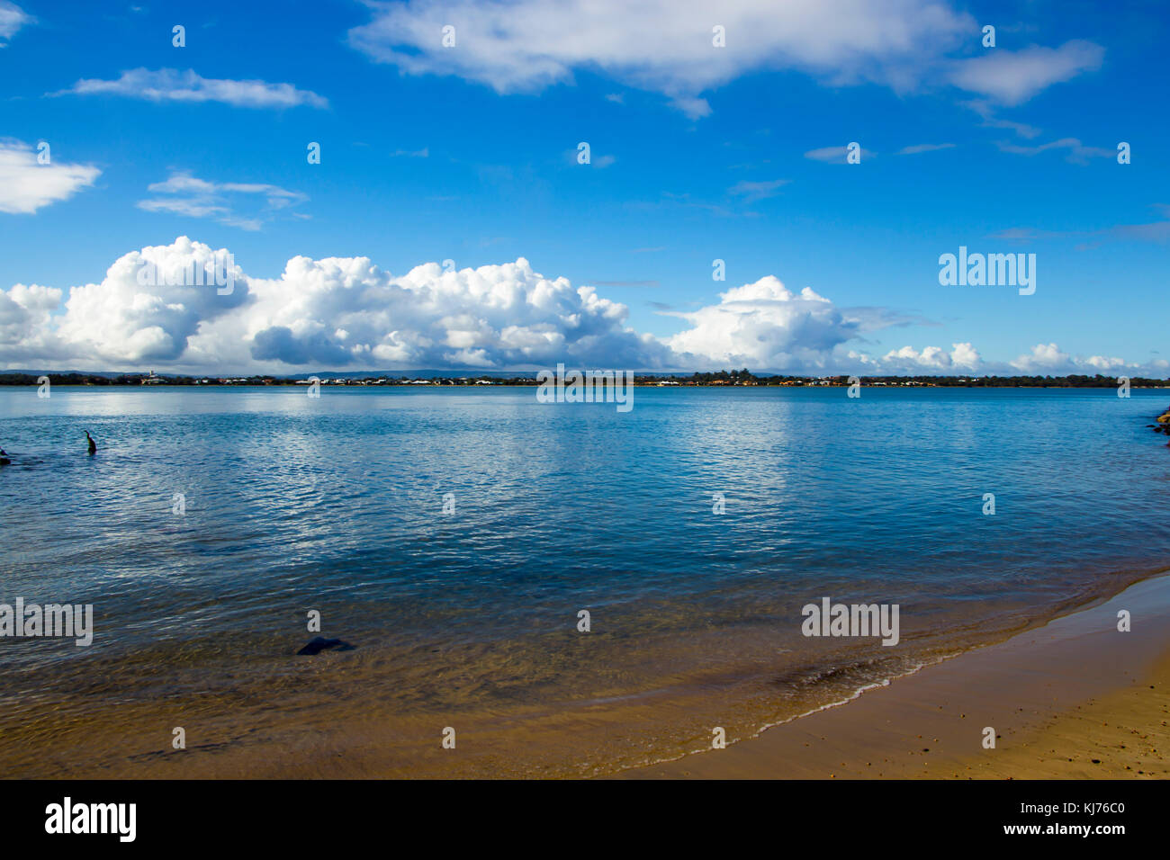 Tranquil view of the landscape from a rocky groyne at the Cut where ...