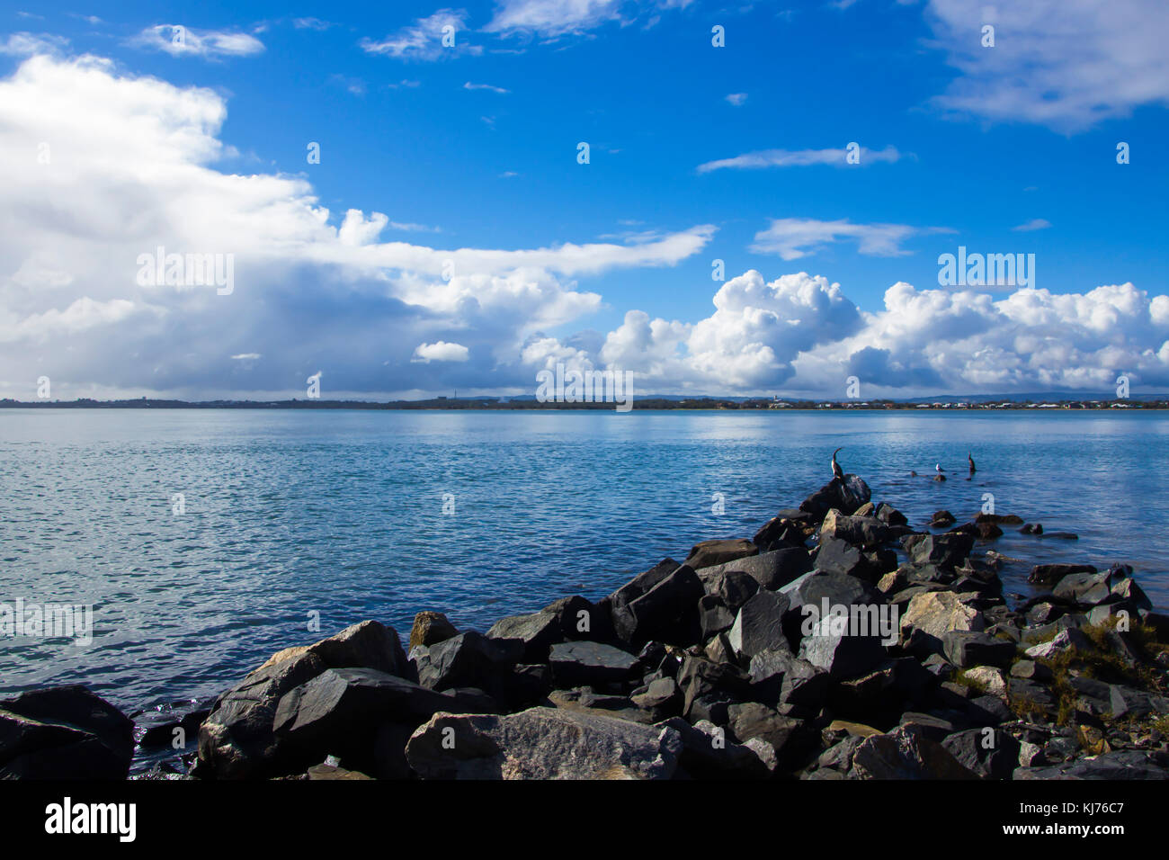 Tranquil view of the landscape from a rocky groyne at the Cut where ...