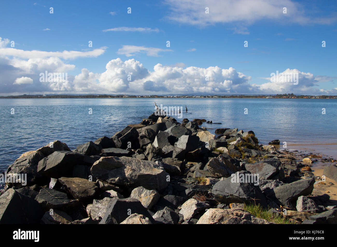 Tranquil view of the landscape from a rocky groyne at the Cut where ...