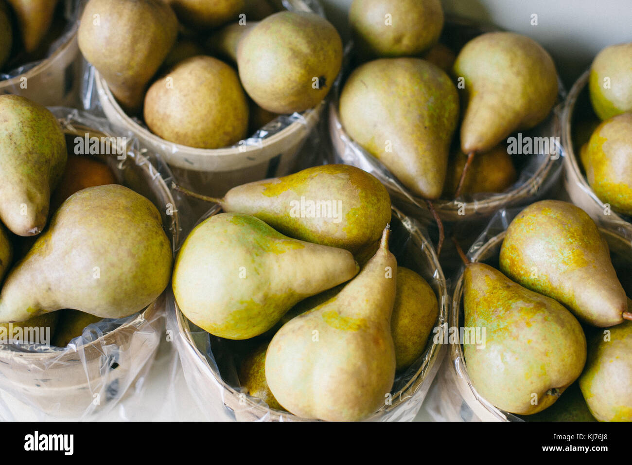 Freshly picked ripe pears in baskets on display at a farmer's market ...
