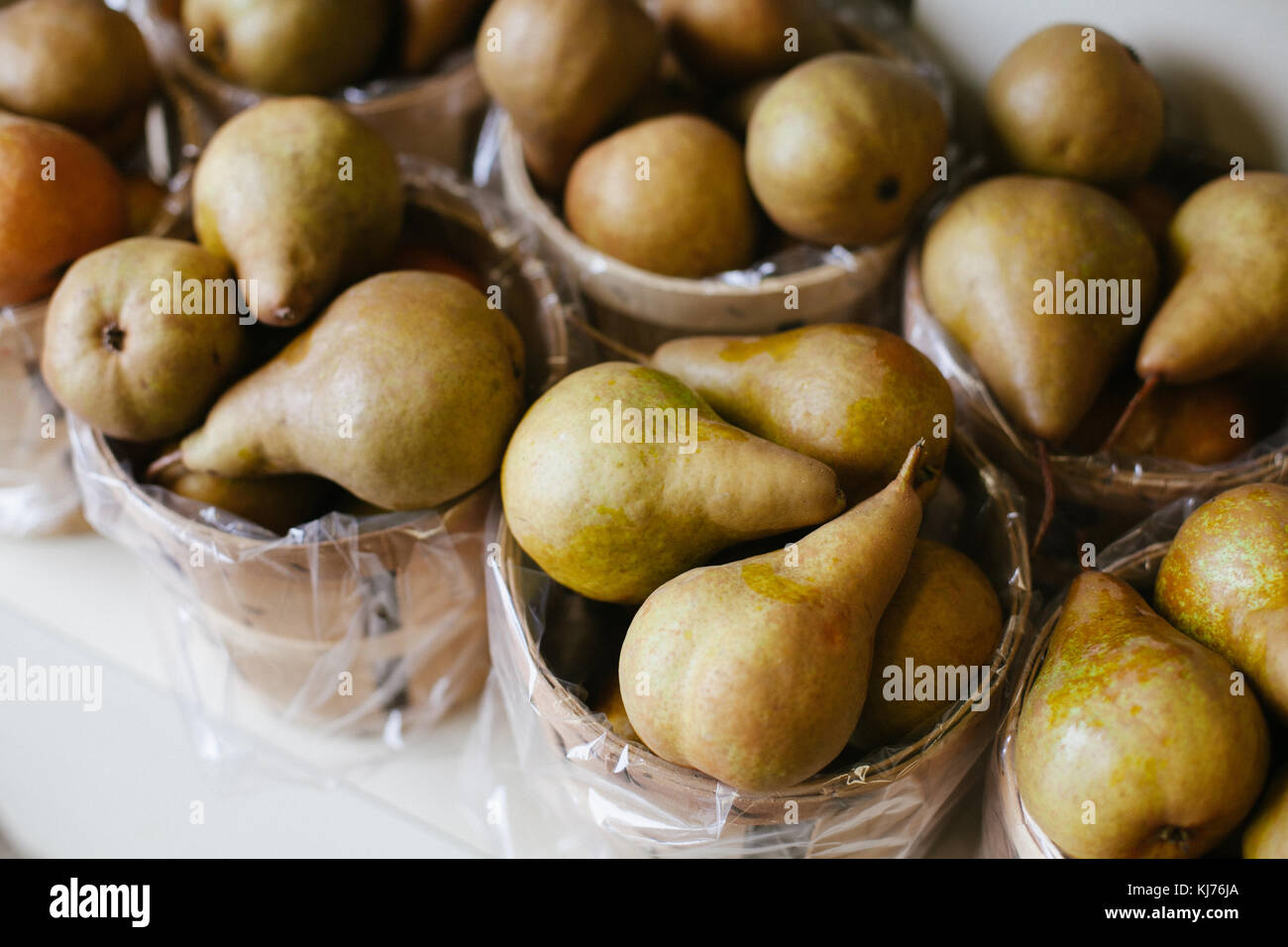 Freshly picked ripe pears in baskets on display at a farmer's market ...