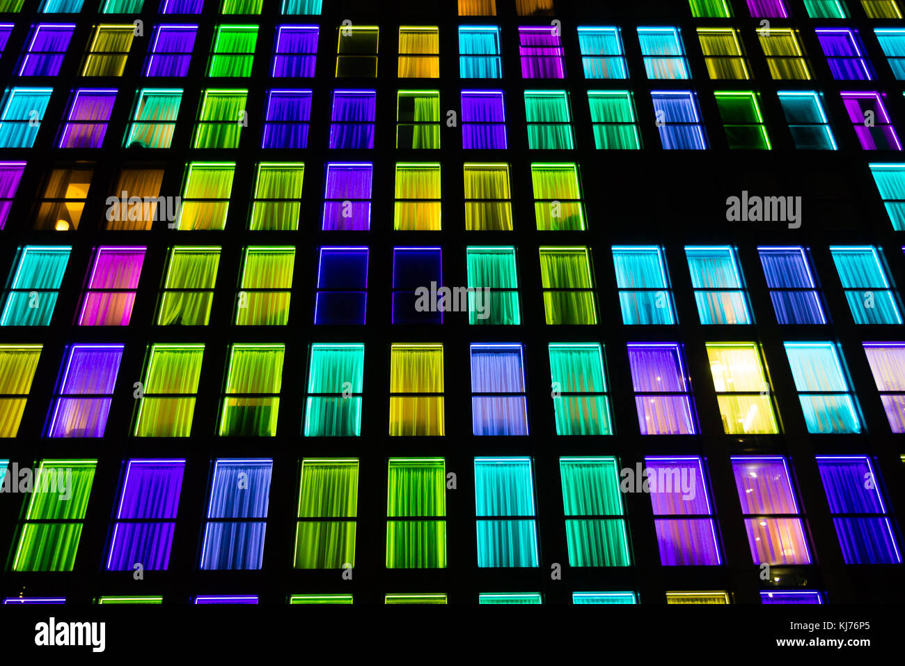 Colored windows texture. Windows illuminated by neon lights background ...