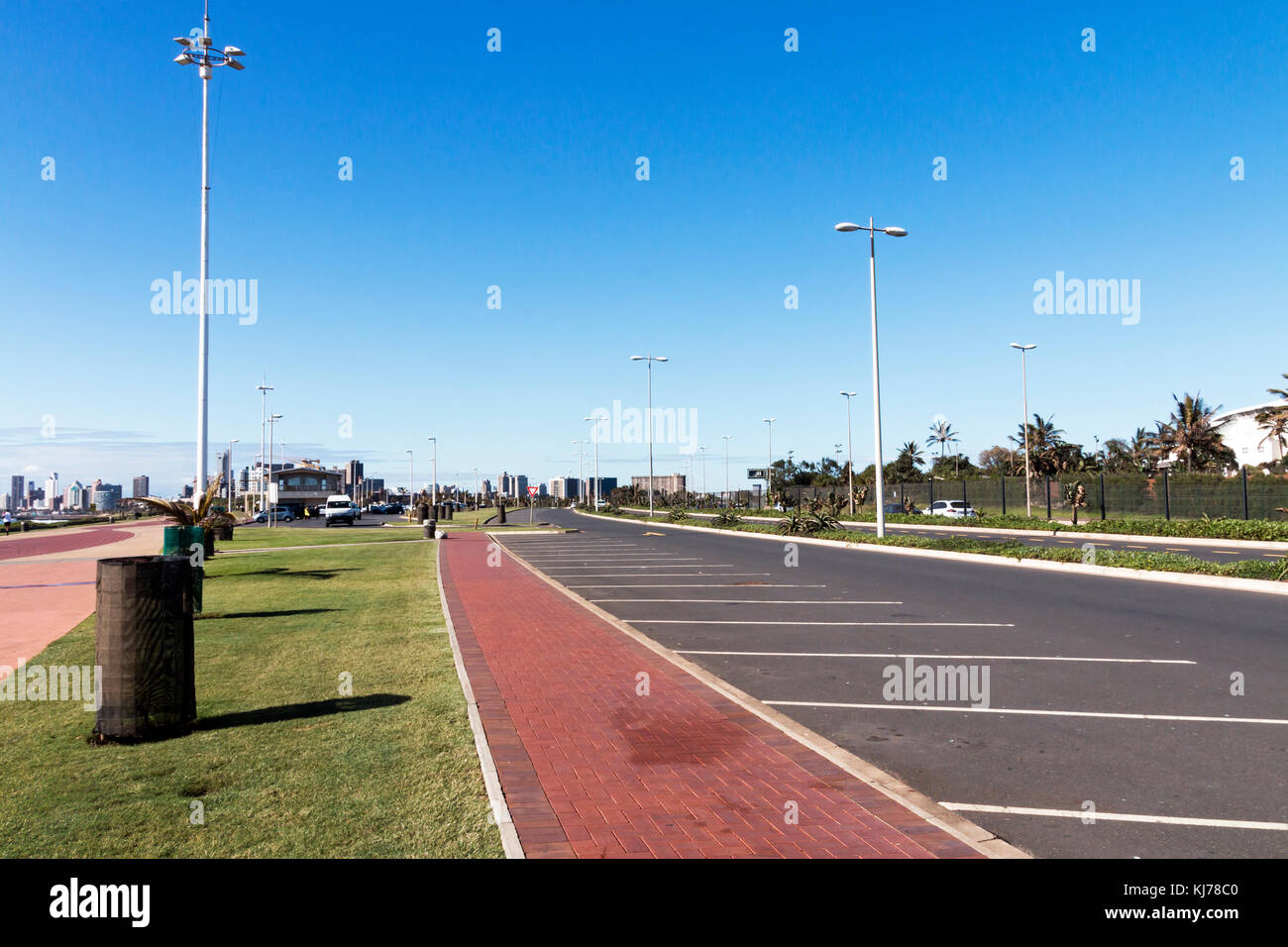 Empty parking bays on beachfront road heading towards Durban city blue ...