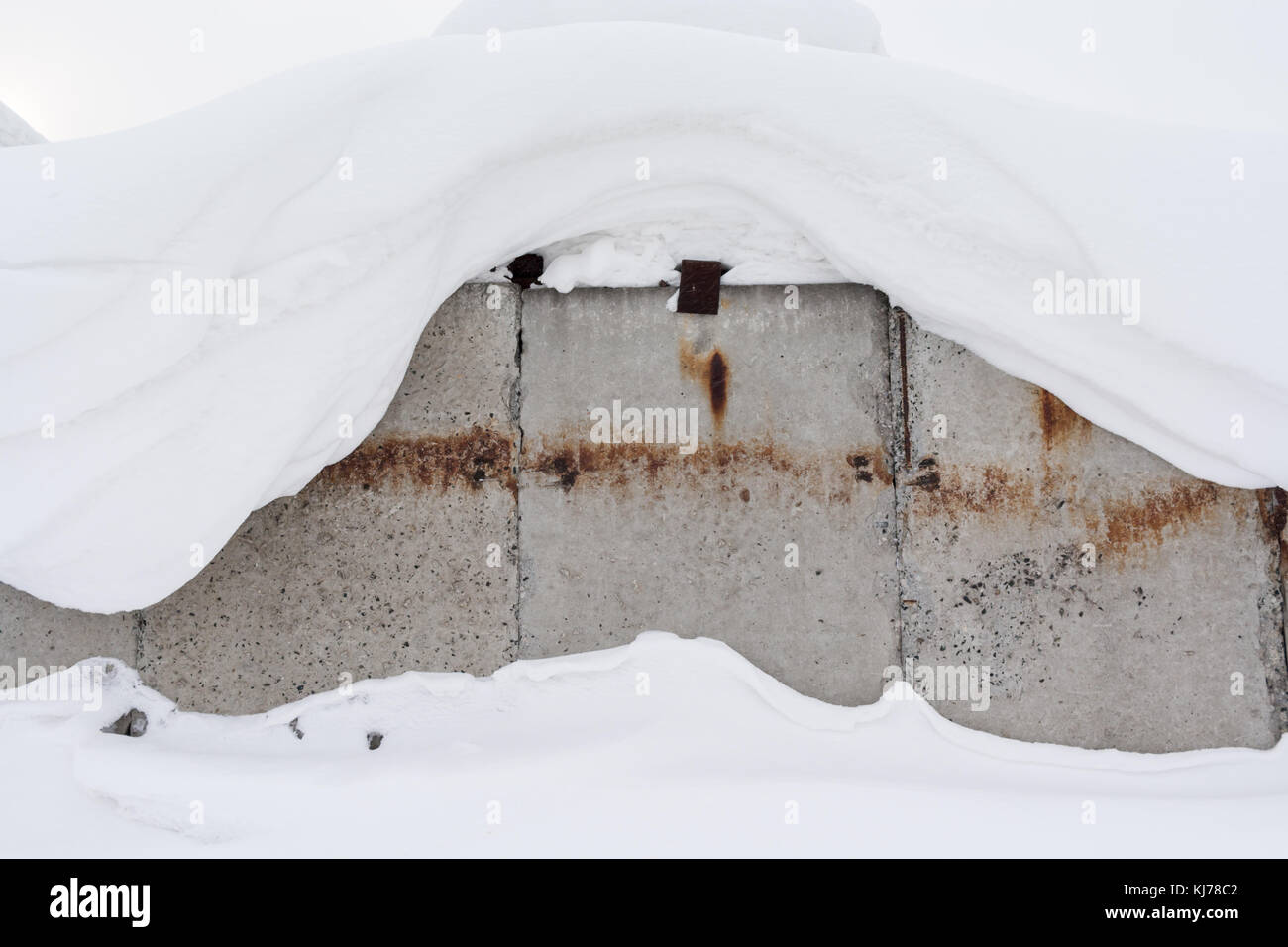 Grey concrete slabs and thick cap of snow on them Stock Photo - Alamy