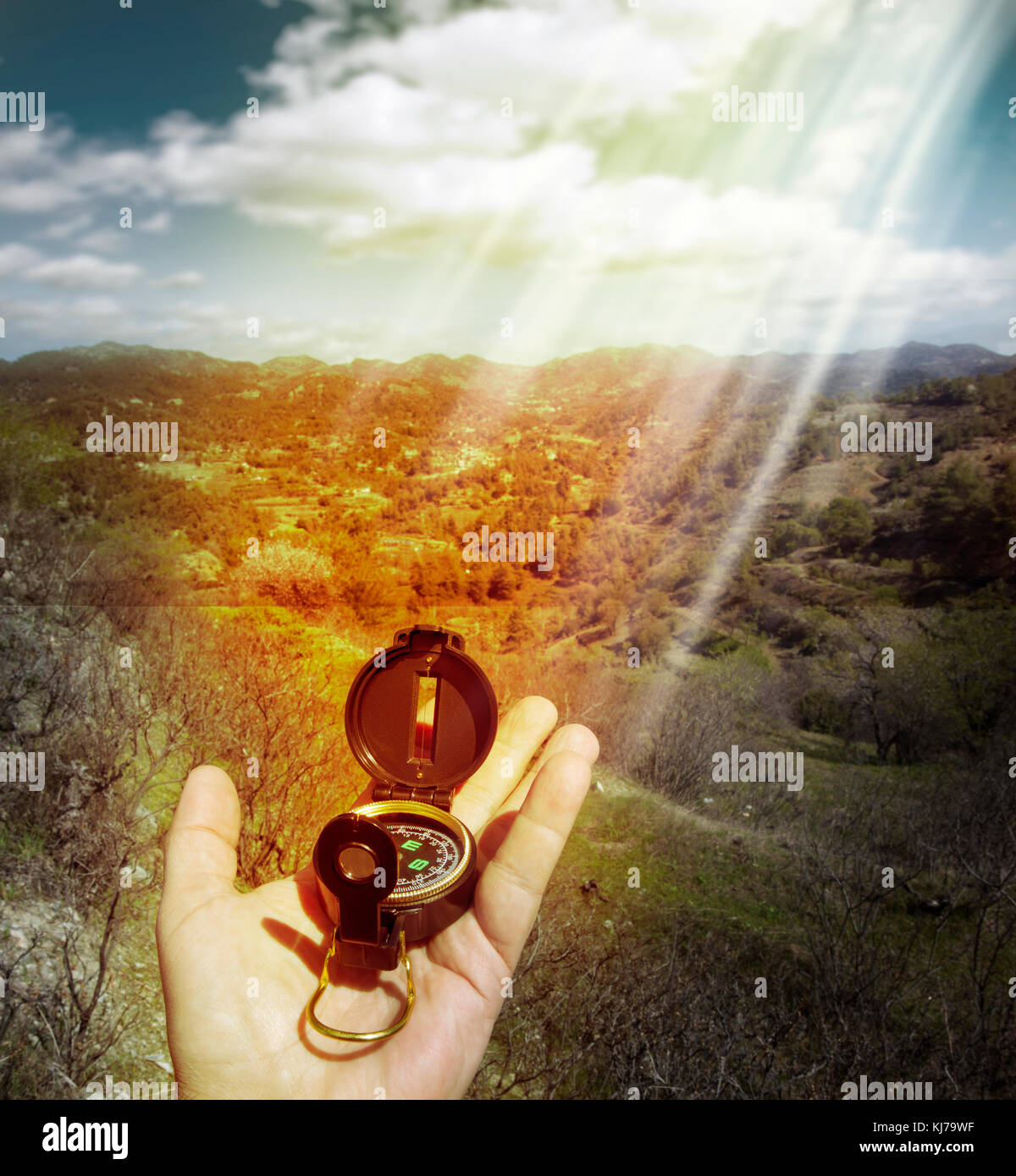 Compass in the hand against rural nature Stock Photo - Alamy