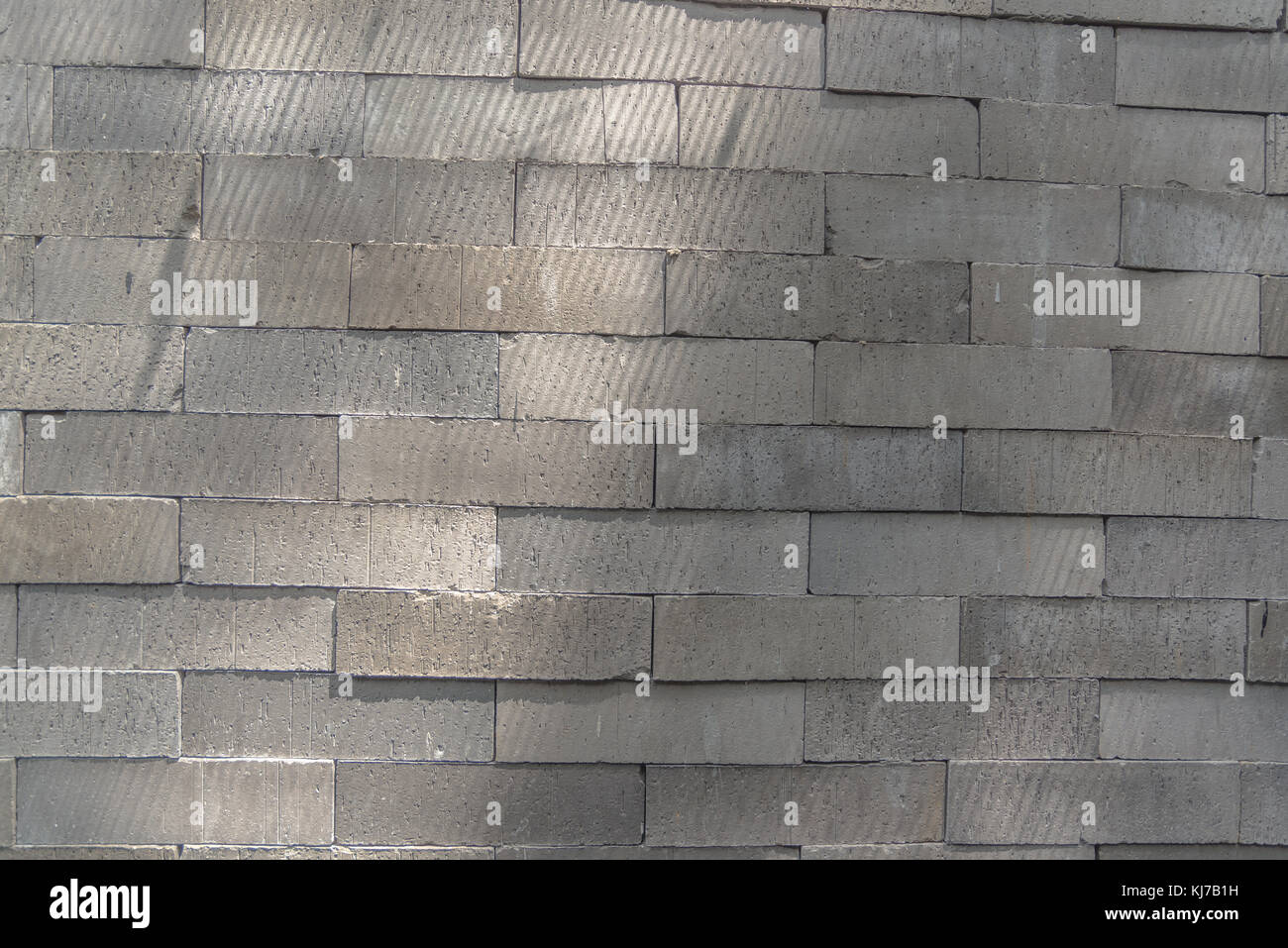 Grey brick wall by concrete block as a background Stock Photo - Alamy