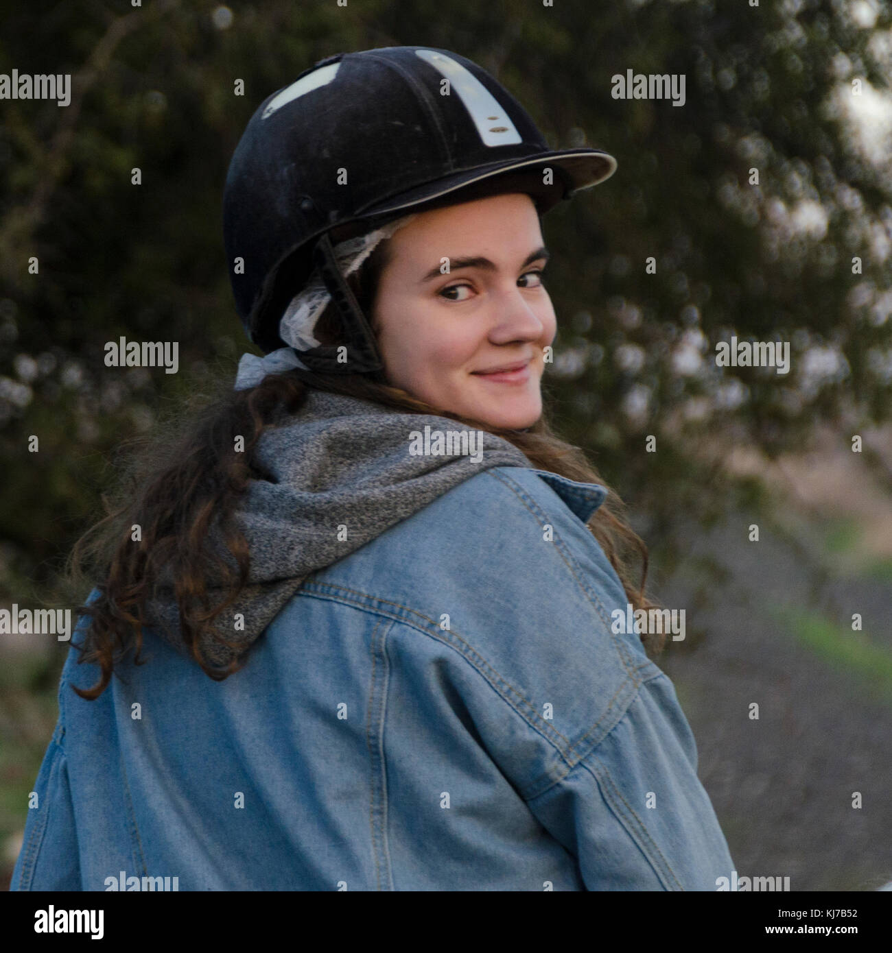 Portrait of teenage girl looking over shoulder and smiling, Galilee ...