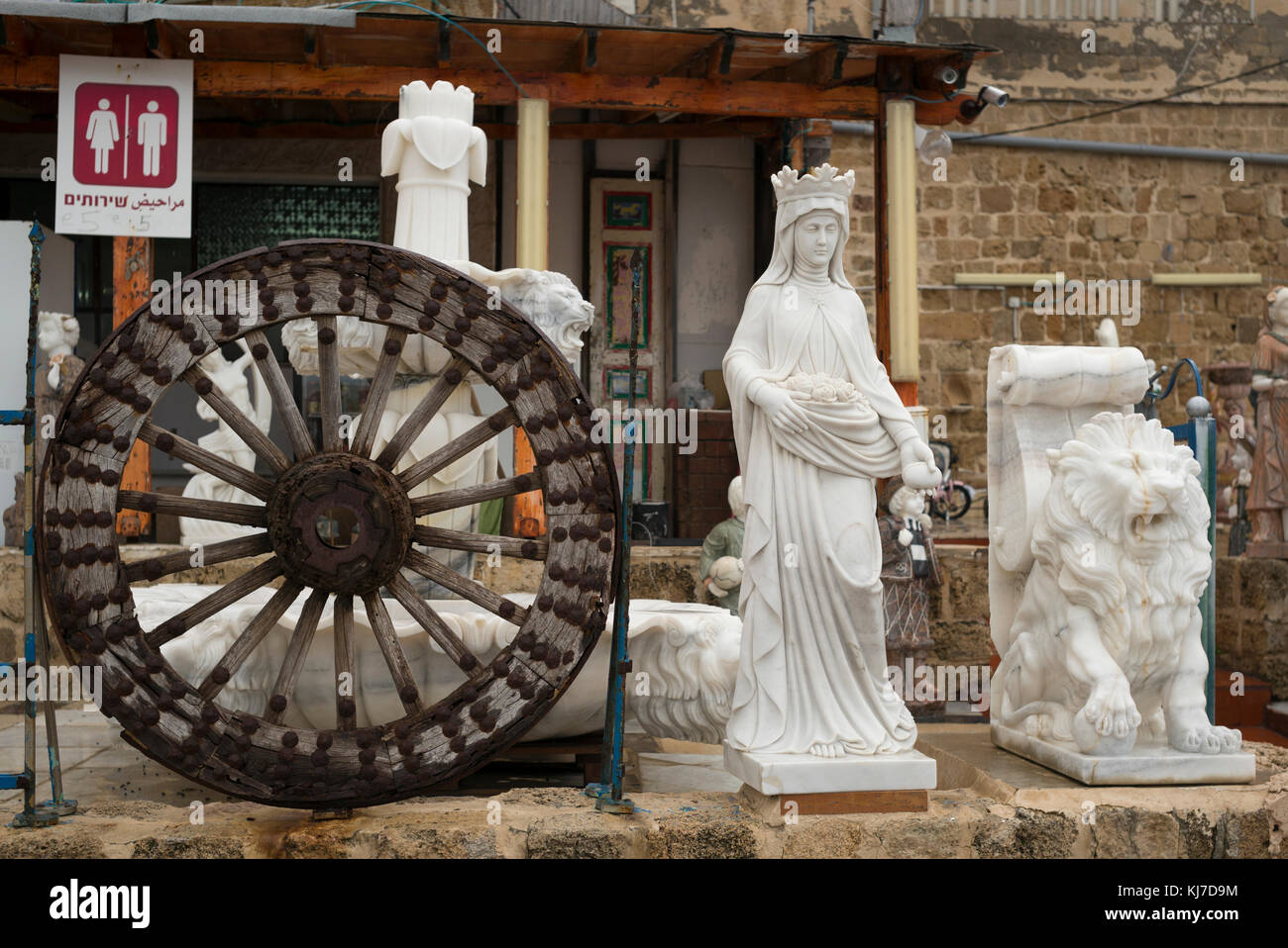 Statues and Wagon wheel outside building, Acre, Israel Stock Photo - Alamy