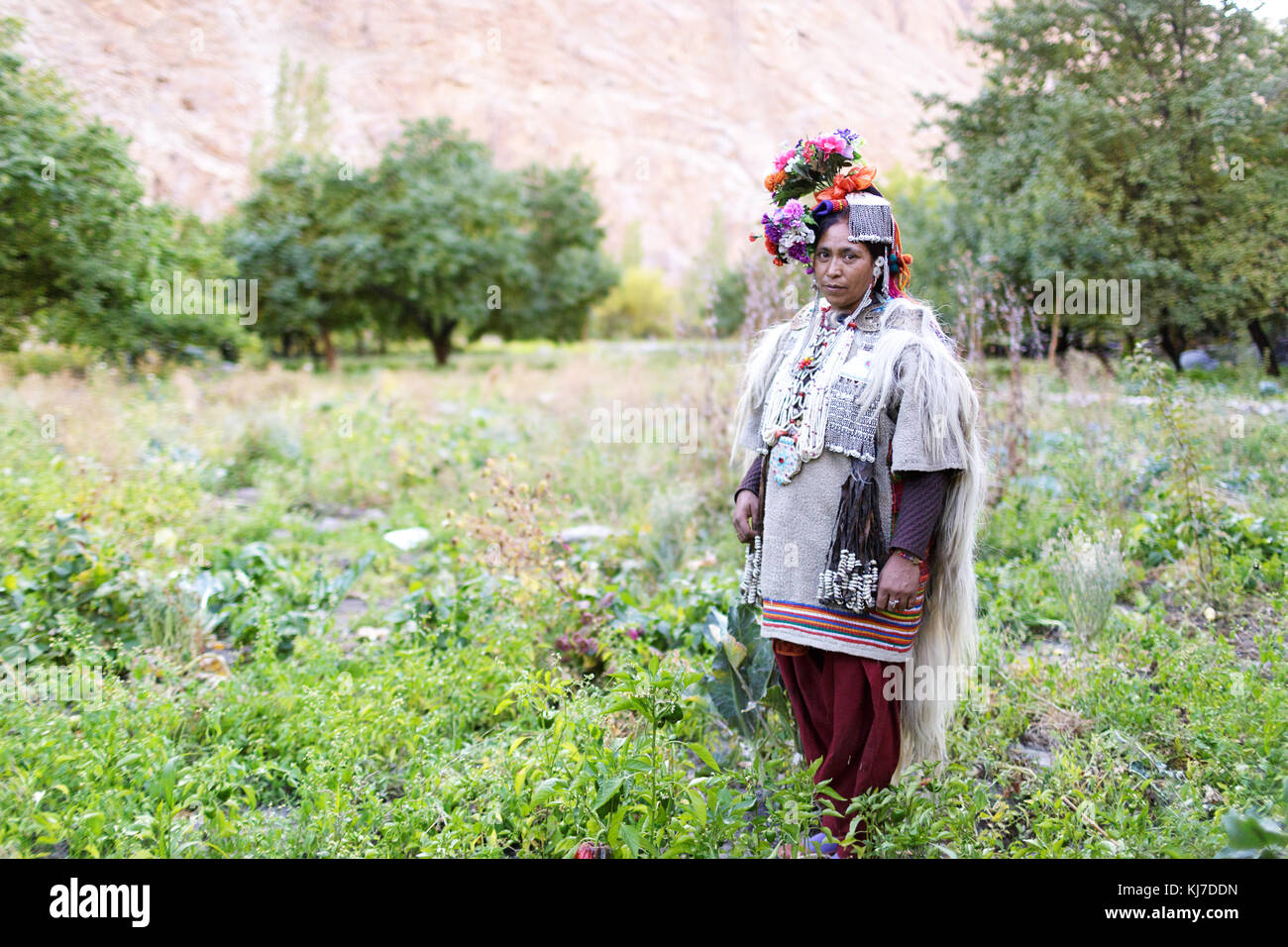 Aryan woman in traditional dress and a hat decorated with flowers ...