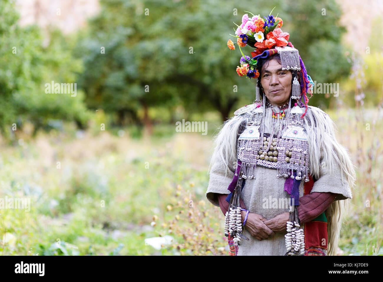 Aryan woman in traditional dress and a hat decorated with flowers ...