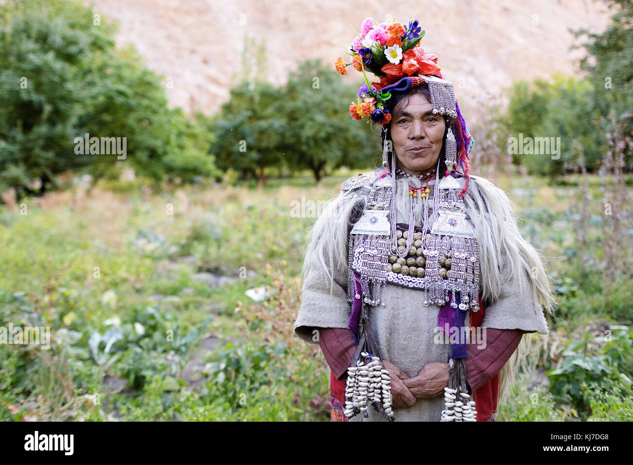 Aryan woman in traditional dress and a hat decorated with flowers ...