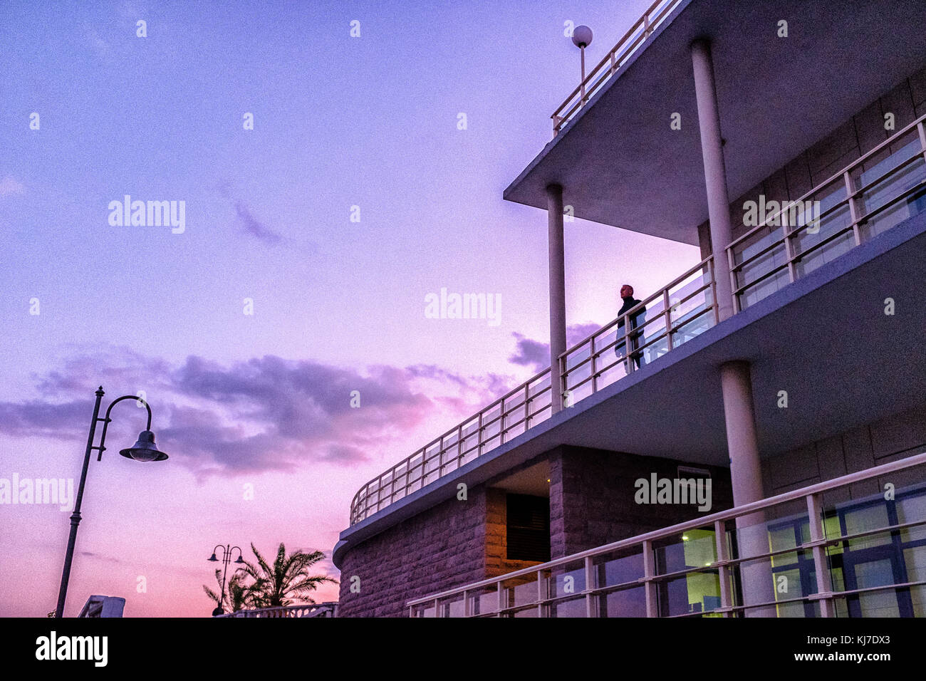 Man stands alone on balcony Stock Photo - Alamy