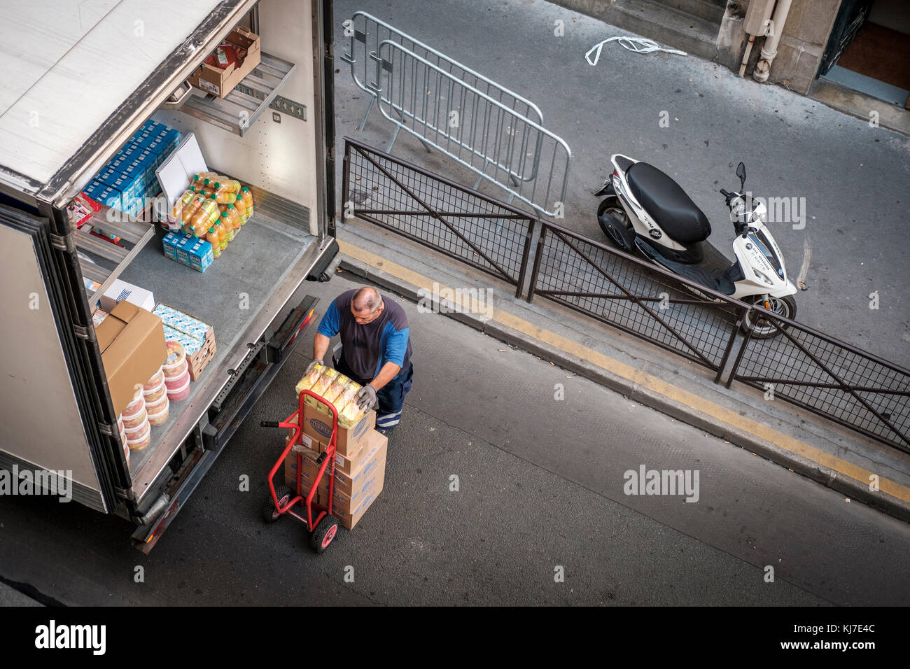 Paris ,France-Middle-aged delivery man unloadsing goods early at the ...