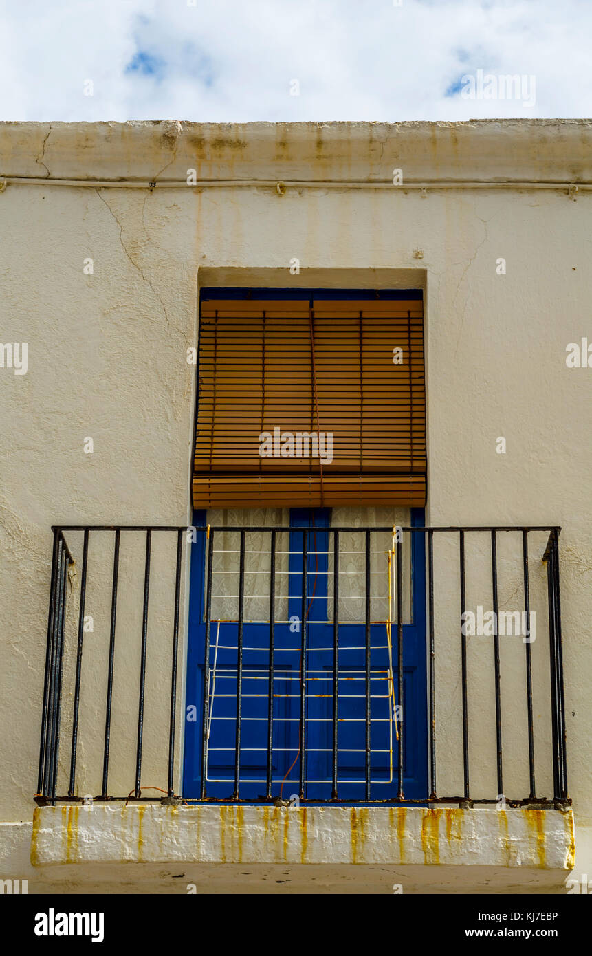 Stylish balcony with a metal railing, solid architectural element, a ...