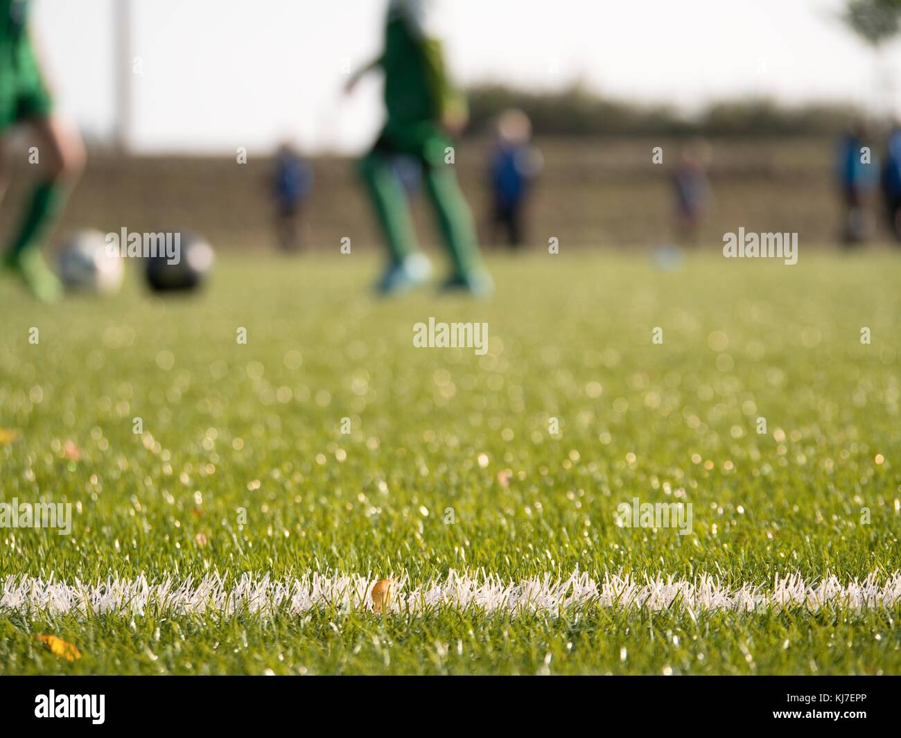 White line marks painted on artificial green turf background. Playfield ...