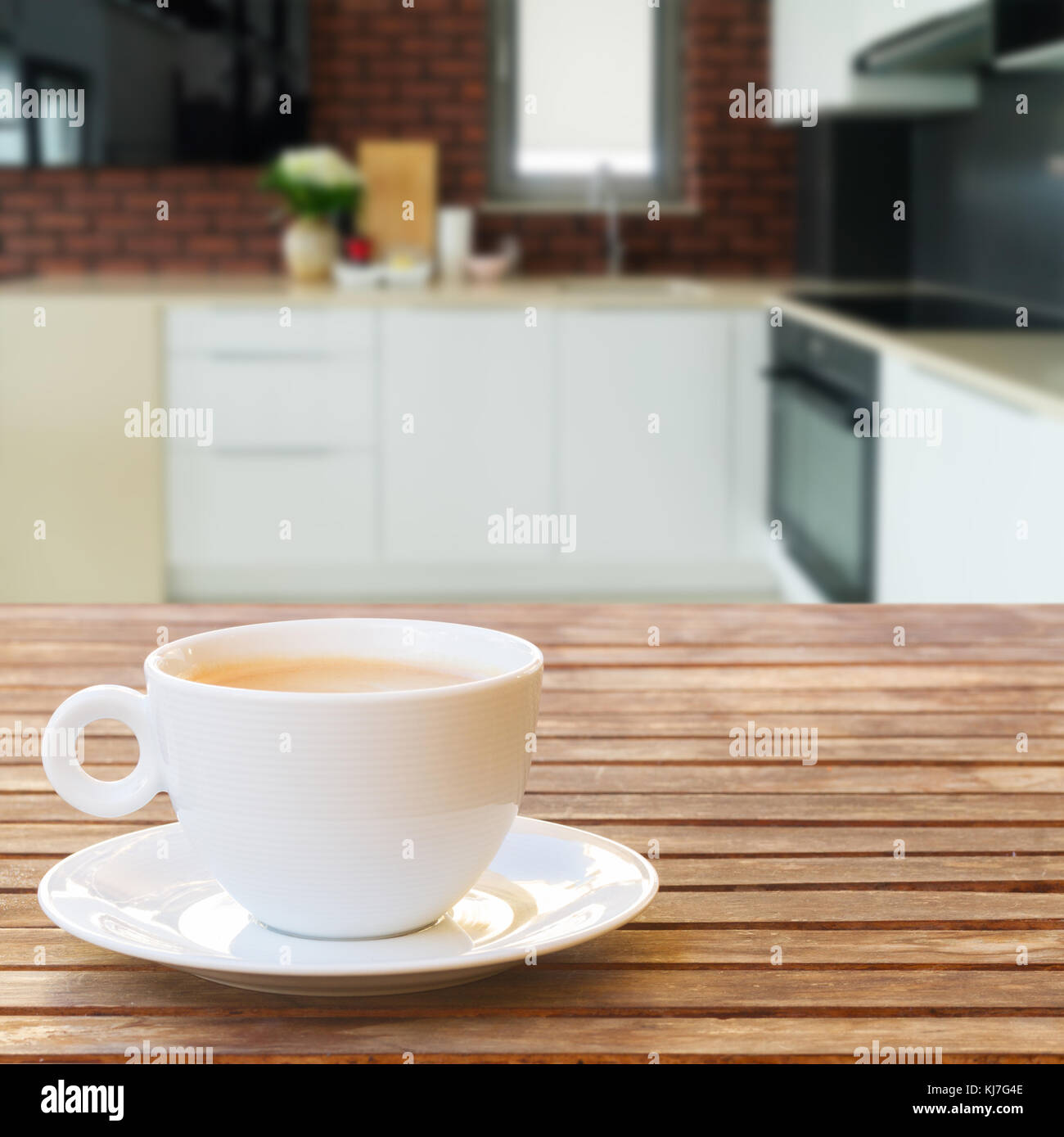 Empty kitchen table top with one coffee cup, modern kitchen in ...