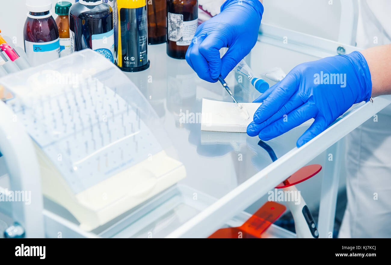 Close up female assistant prepares material for treatment, anesthetic ...
