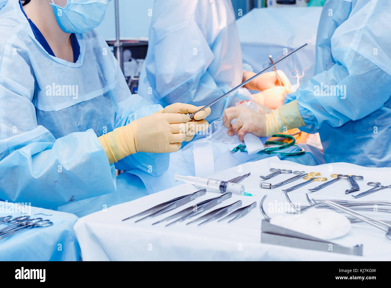 Close up hands of surgery assistant holding steralized surgical tools ...