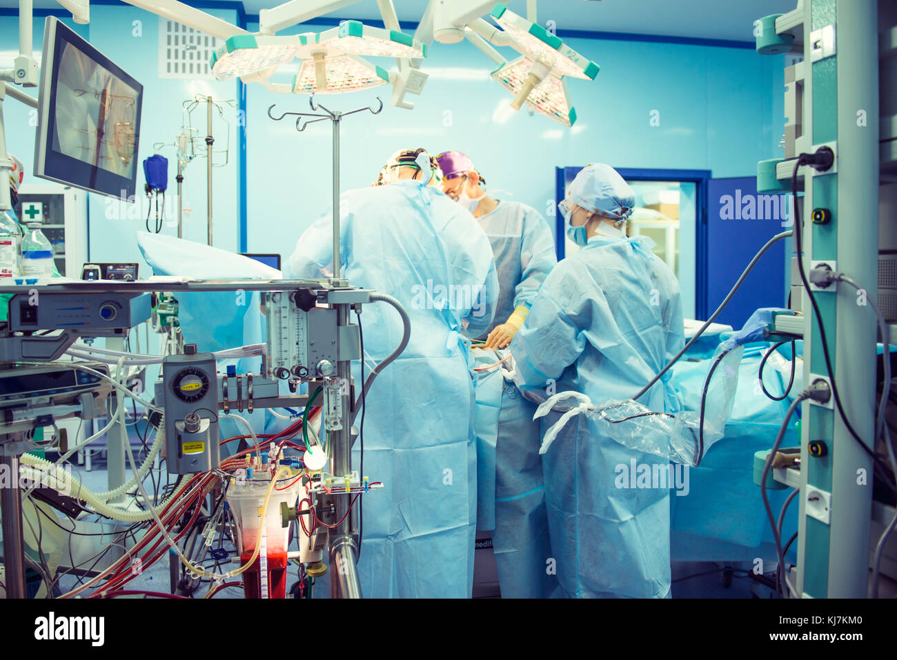 Team of surgeon in uniform perform operation on a patient using ...
