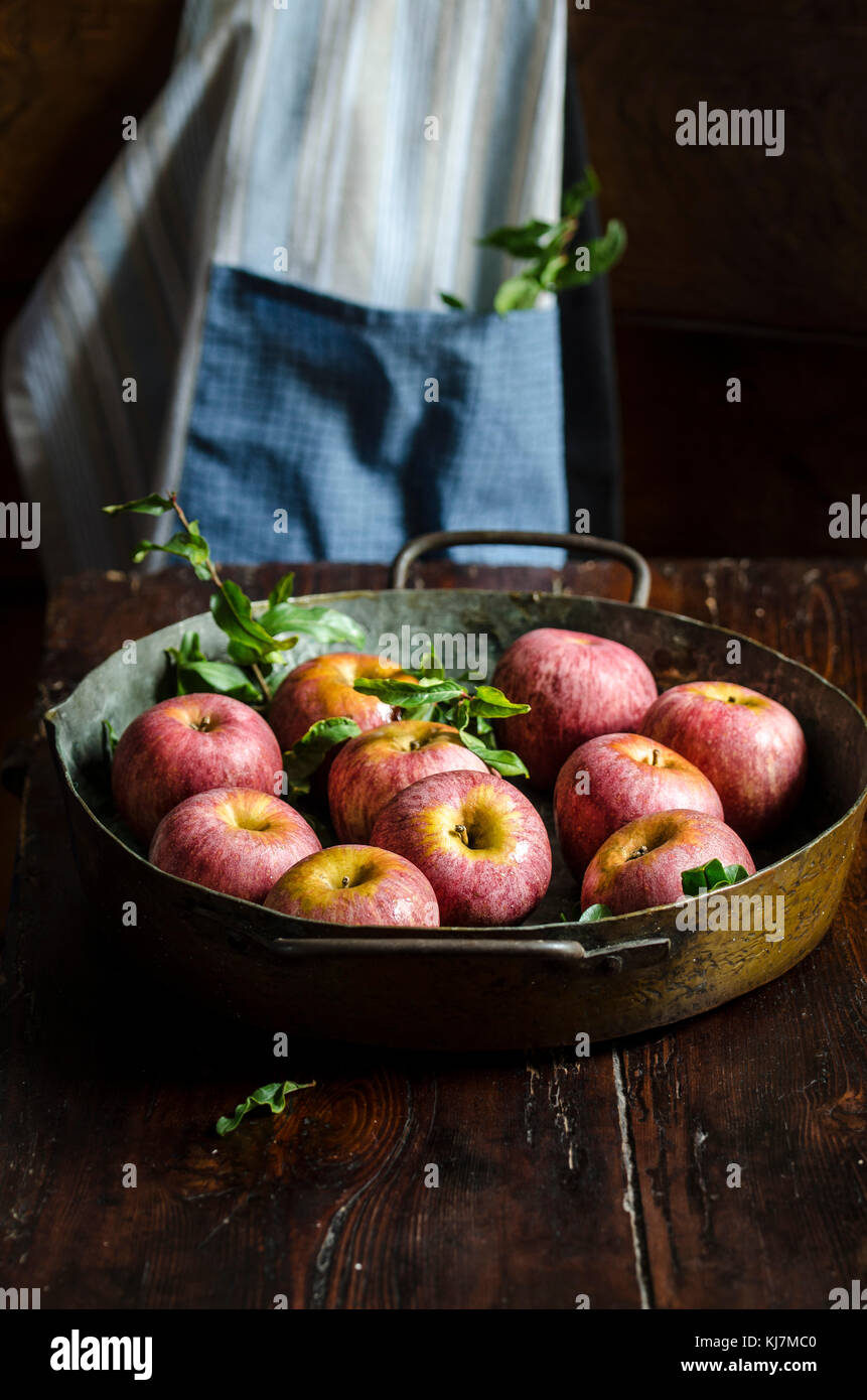 Apples on a rustic kitchen table Stock Photo - Alamy