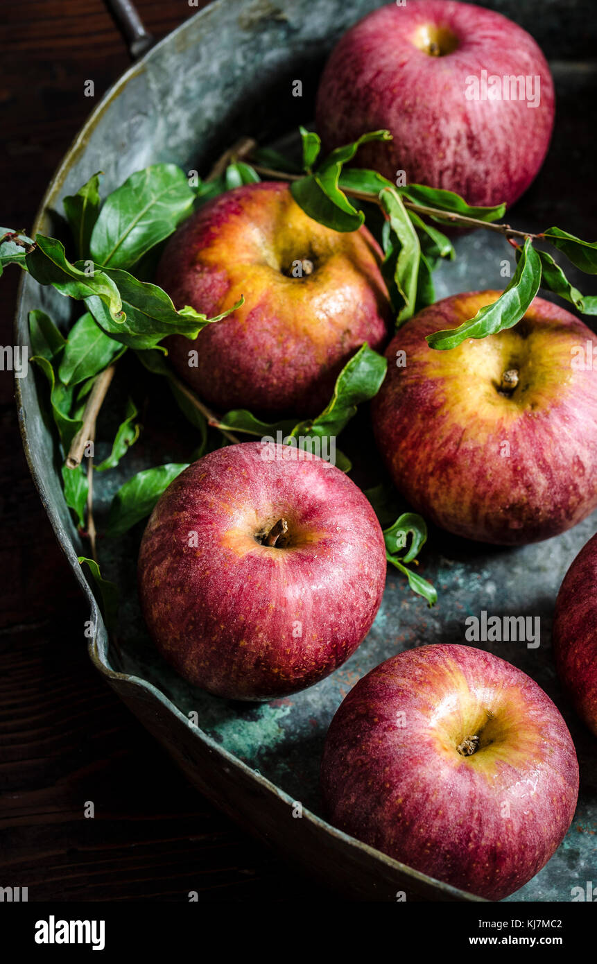 Apples on a rustic kitchen table Stock Photo - Alamy