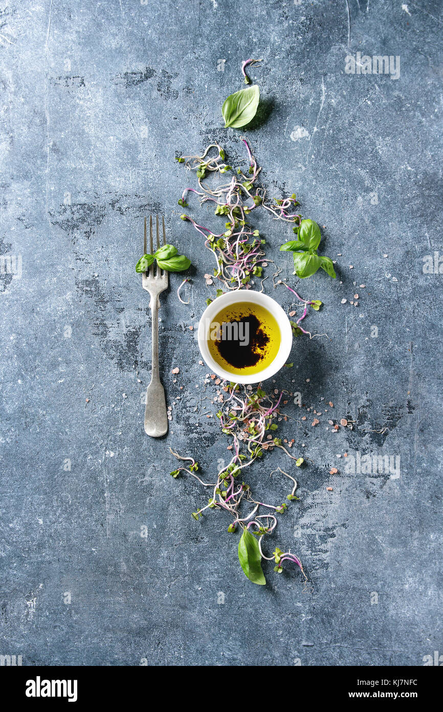 Young radish sprouts with pink himalayan salt and basil leaves with ...