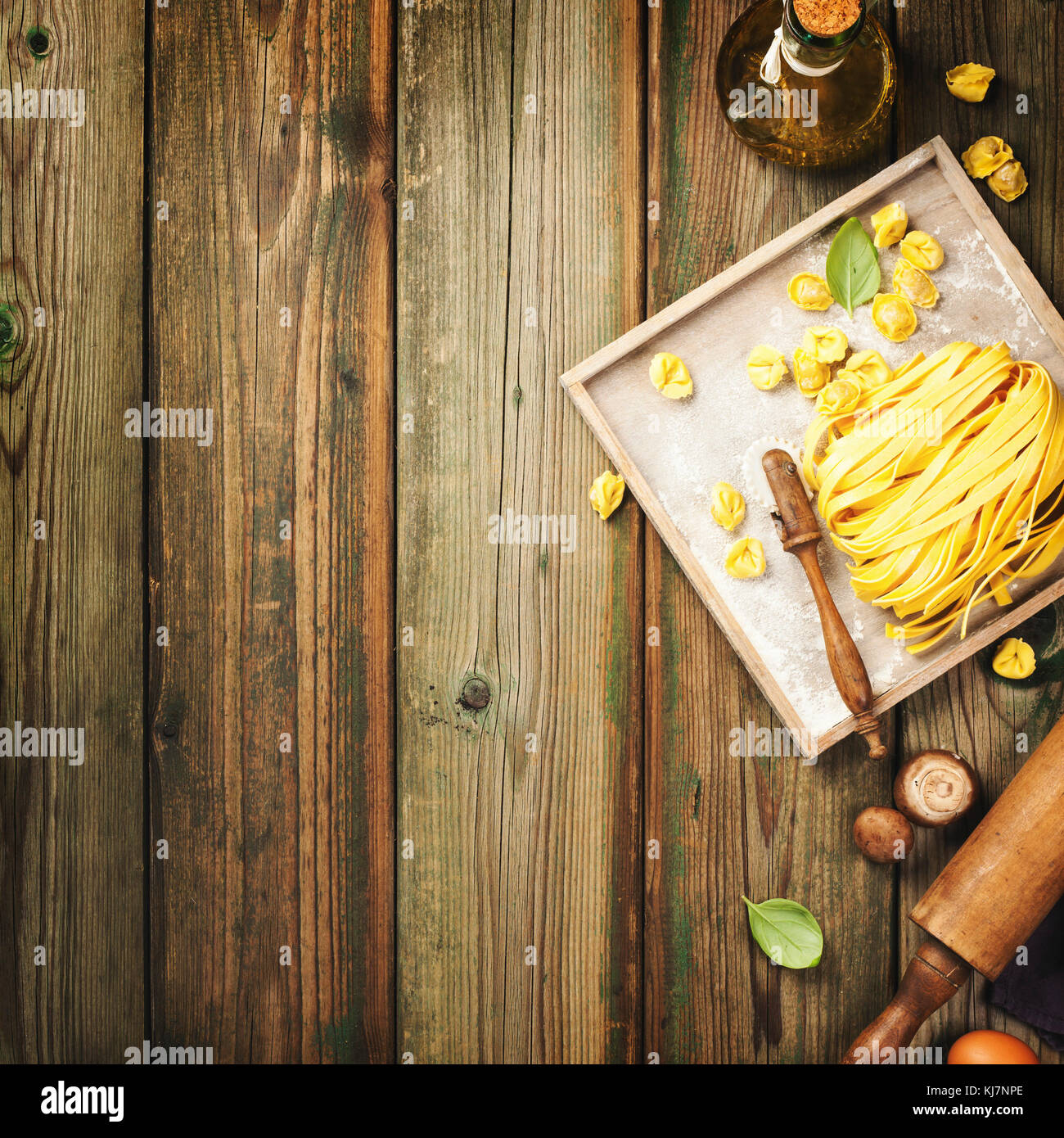 Cooking background with fresh pasta tagliatelle and mushrooms Stock ...