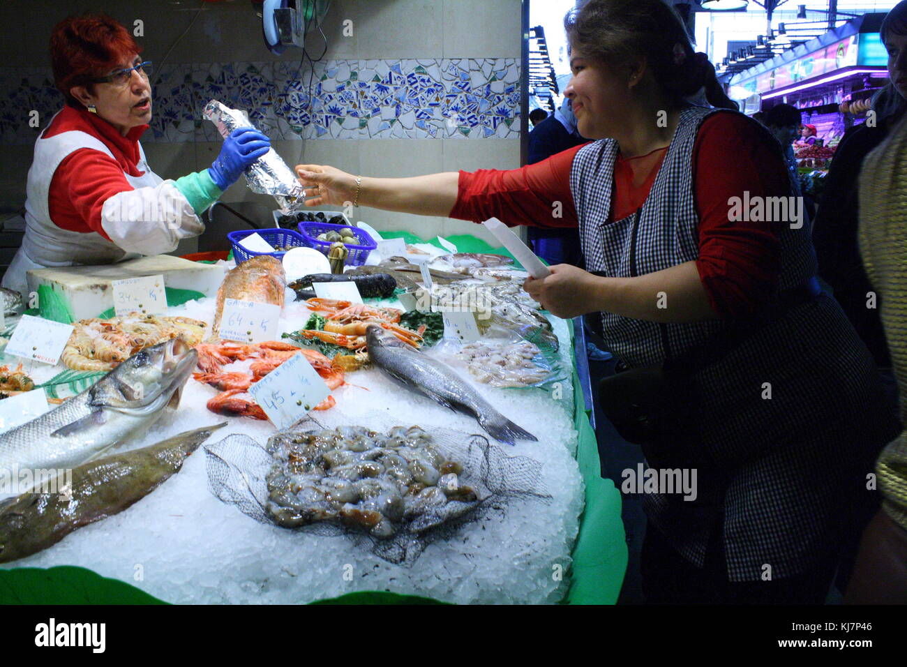 A vendor sells fish for sale at the marine food market in Barcelona ...