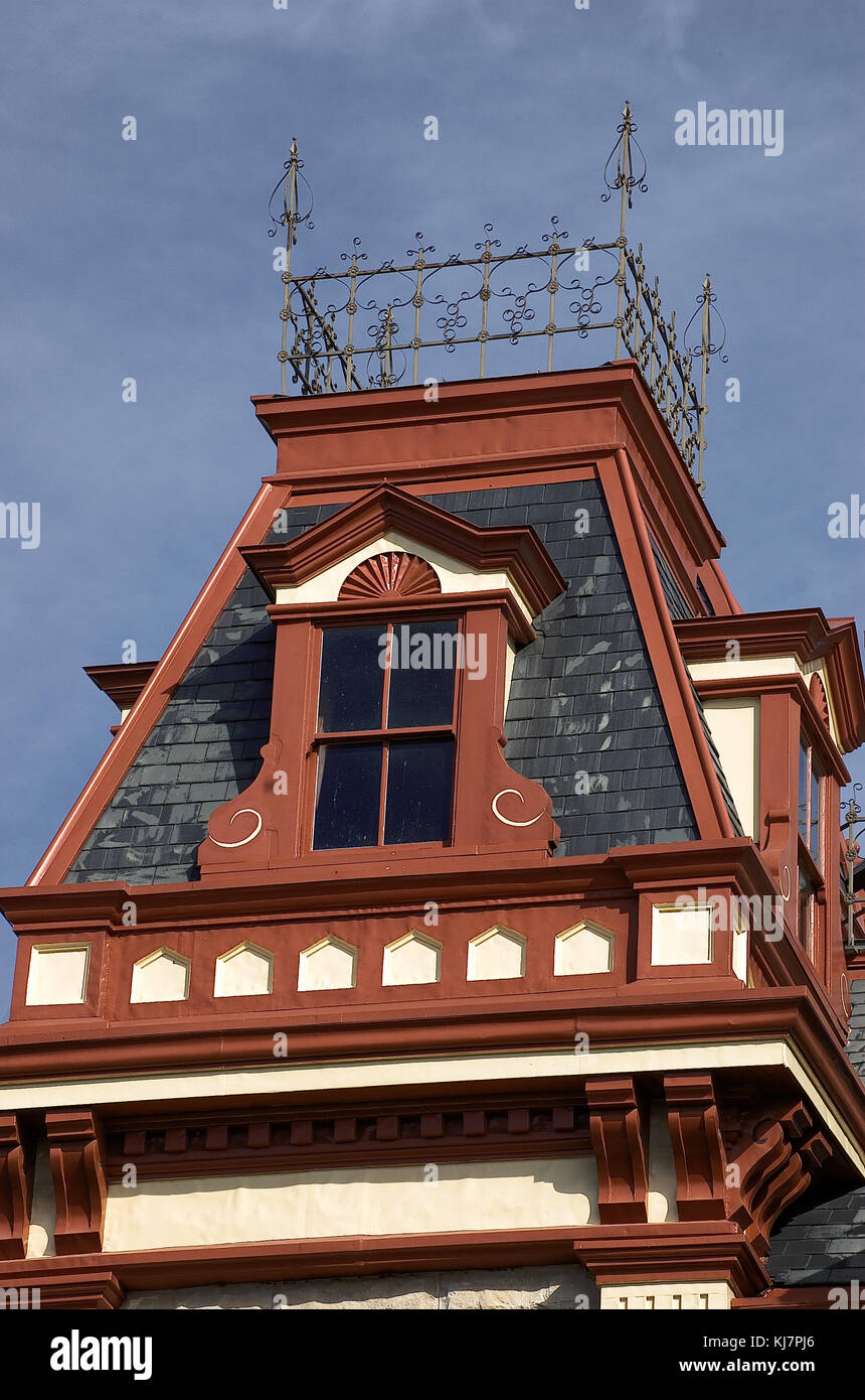 Elaborate window of rock building with balcony on roof Stock Photo - Alamy