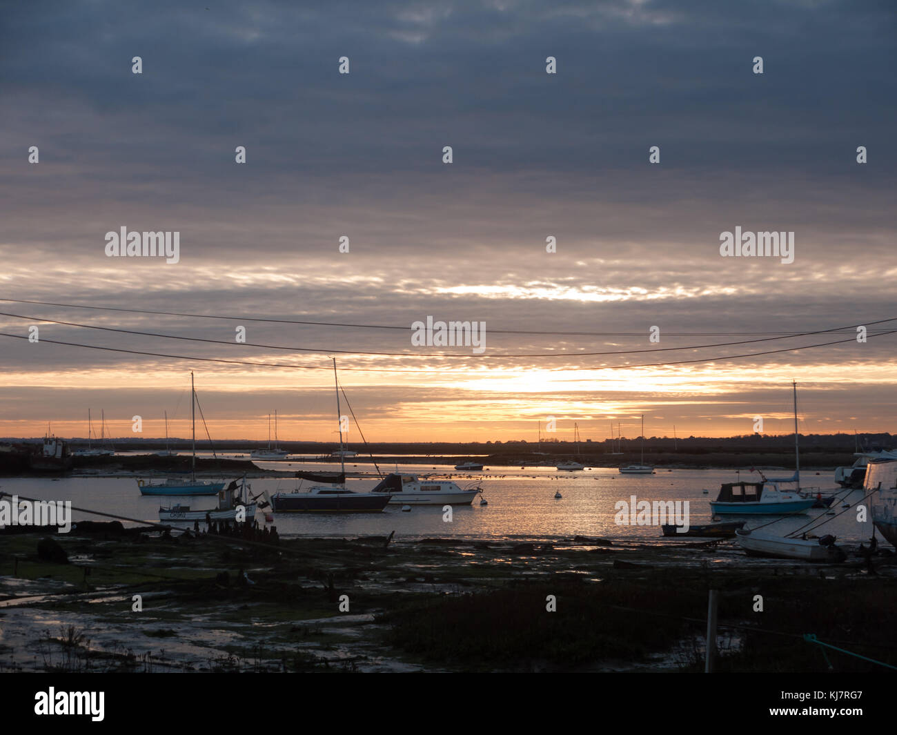 sun set sky dramatic clouds sea front beach harbor marina boats moored ...