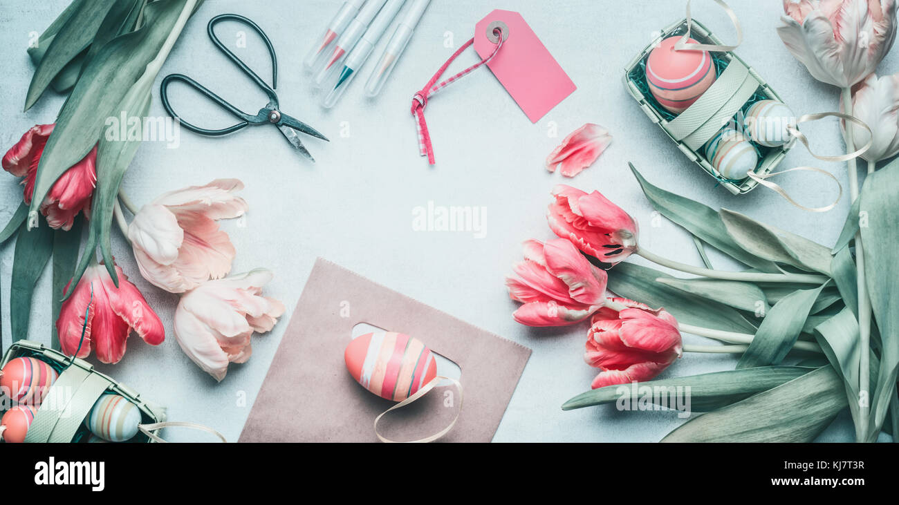 Lovely pastel color Easter flat lay with eggs, tulips, scissors and ...