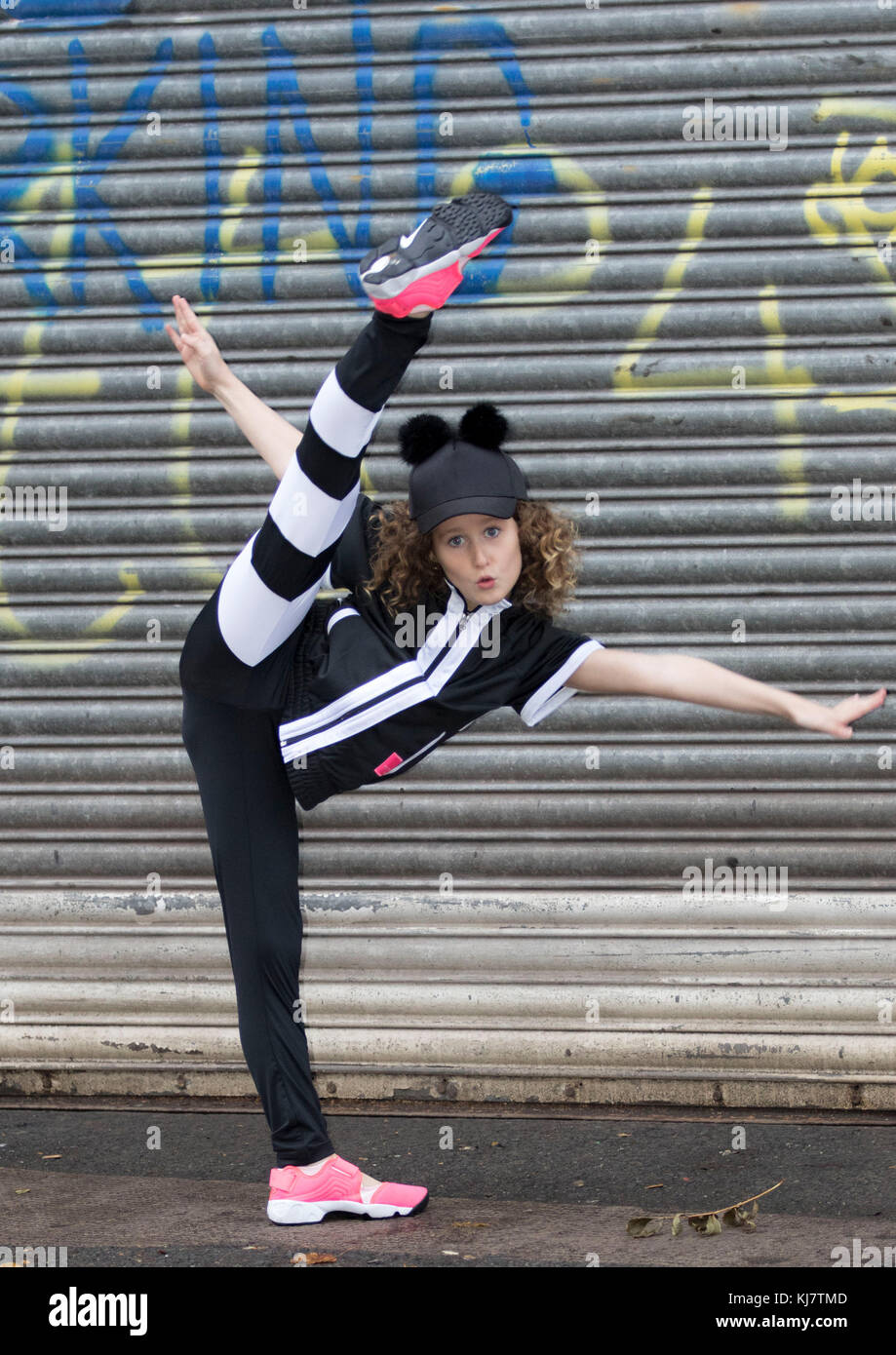Dancer tilt kick infront of a graffiti shutter 25th october 2017 Stock ...