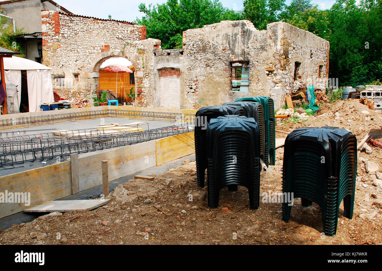 A house foundation site with steel reinforcement cages surrounded by ...