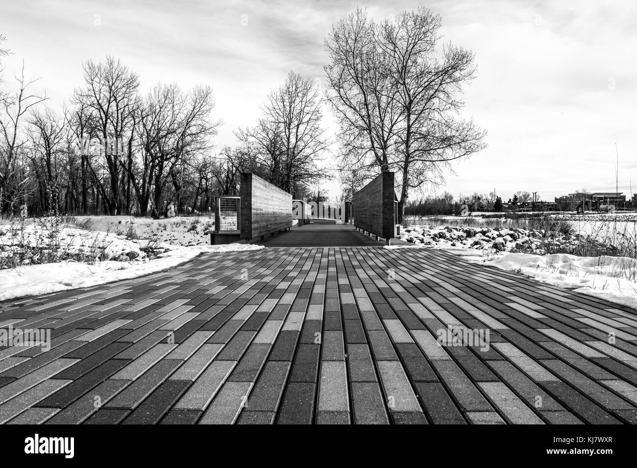 A pedestrian bridge over a small river in winter Stock Photo - Alamy