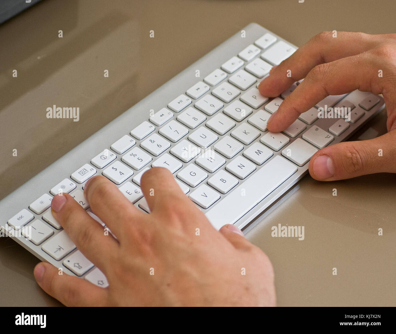 Hands typing on the remote wireless computer keyboard - using ...