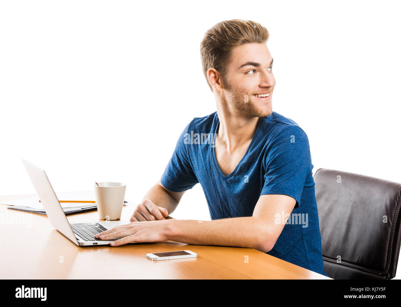Young student sitting on the desk working with a laptop Stock Photo - Alamy