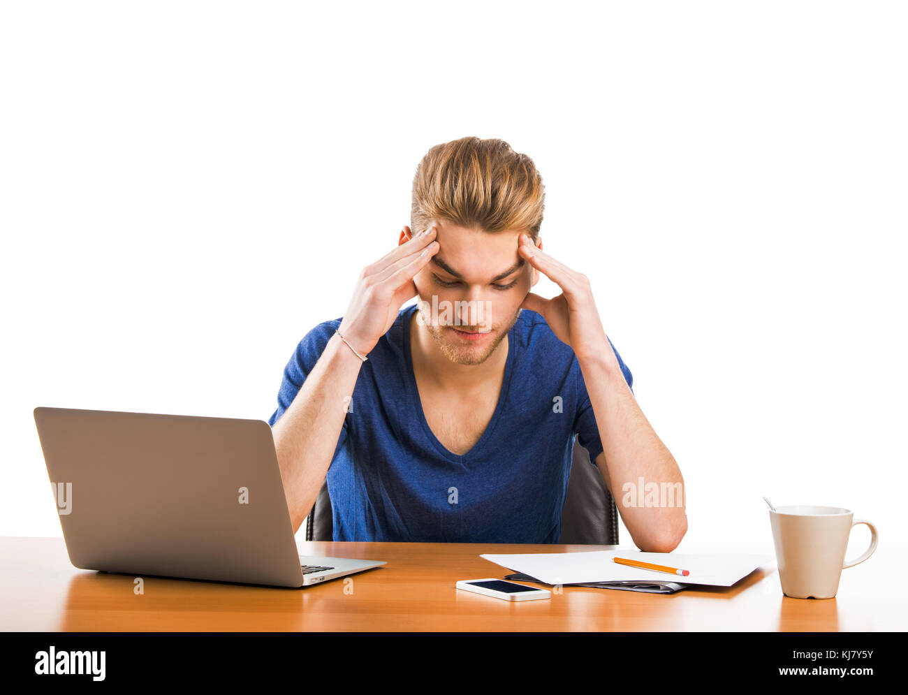 Young student sitting on the desk working with a laptop Stock Photo - Alamy