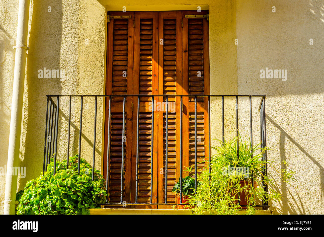 Stylish balcony with a metal railing, solid architectural element, a ...