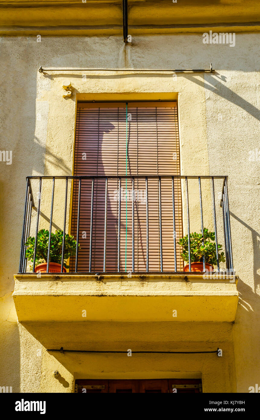 Stylish balcony with a metal railing, solid architectural element, a ...