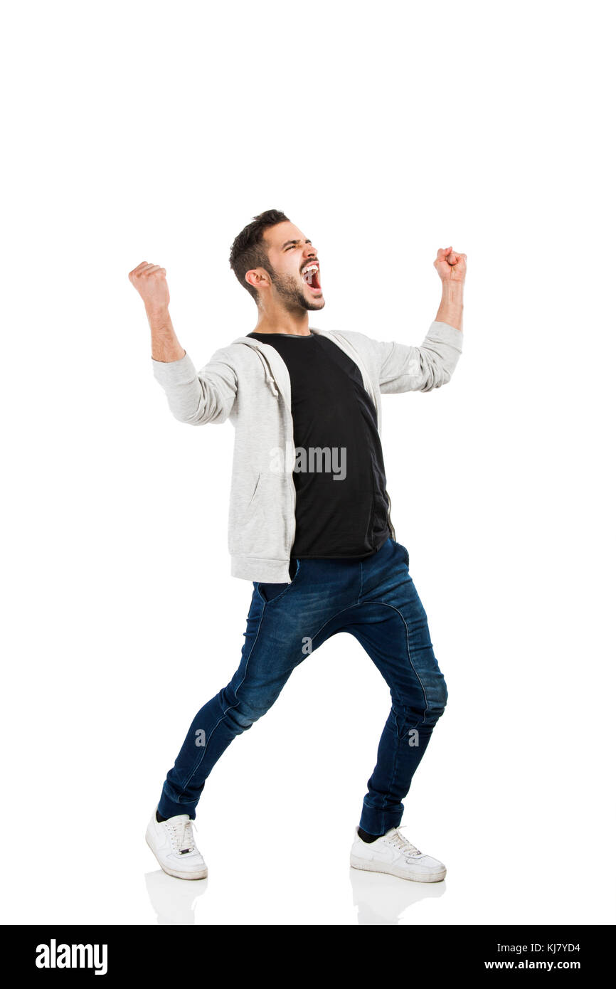 Successful young latin man with arms up Stock Photo - Alamy