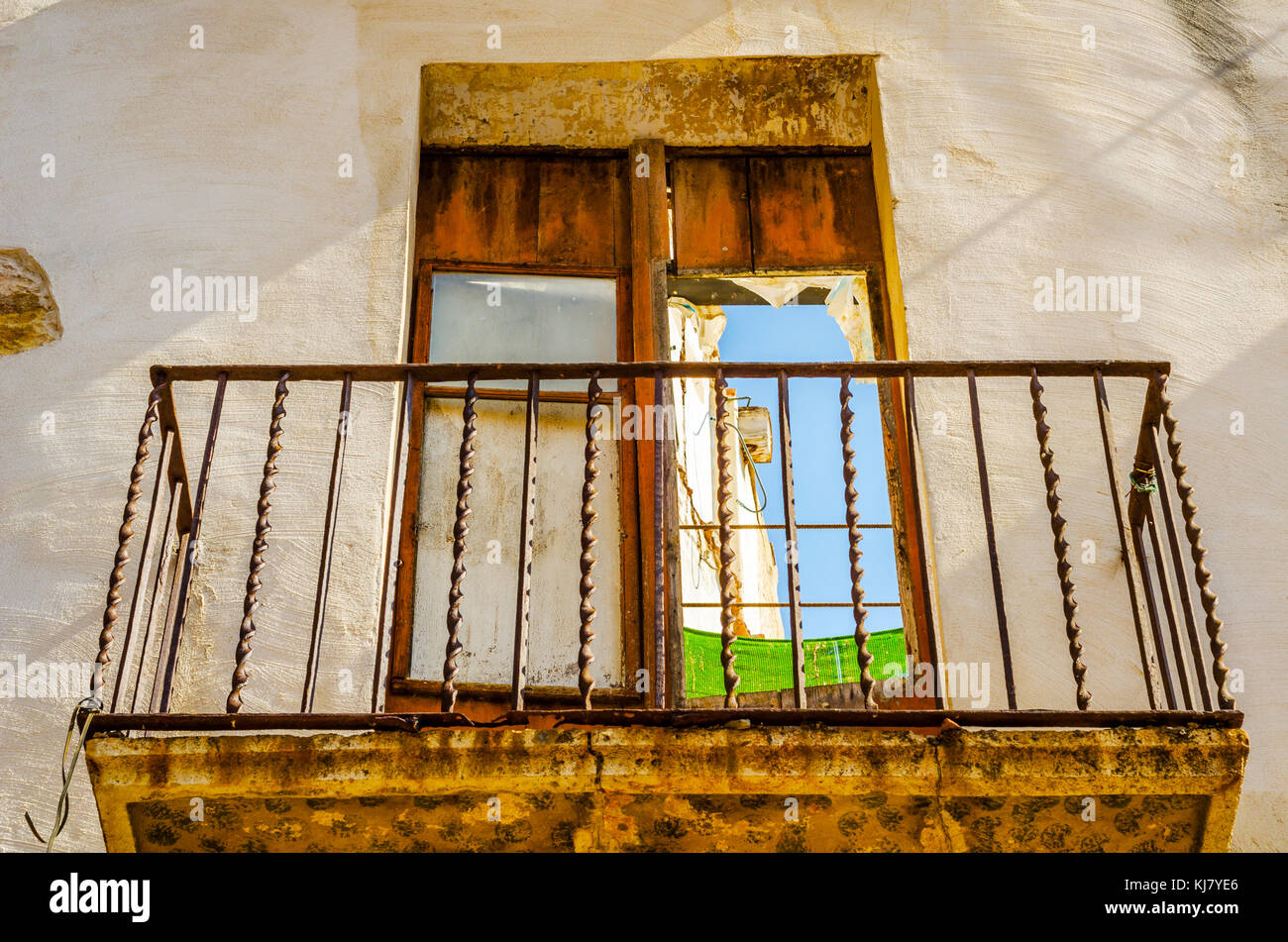 Stylish balcony with a metal railing, solid architectural element, a ...