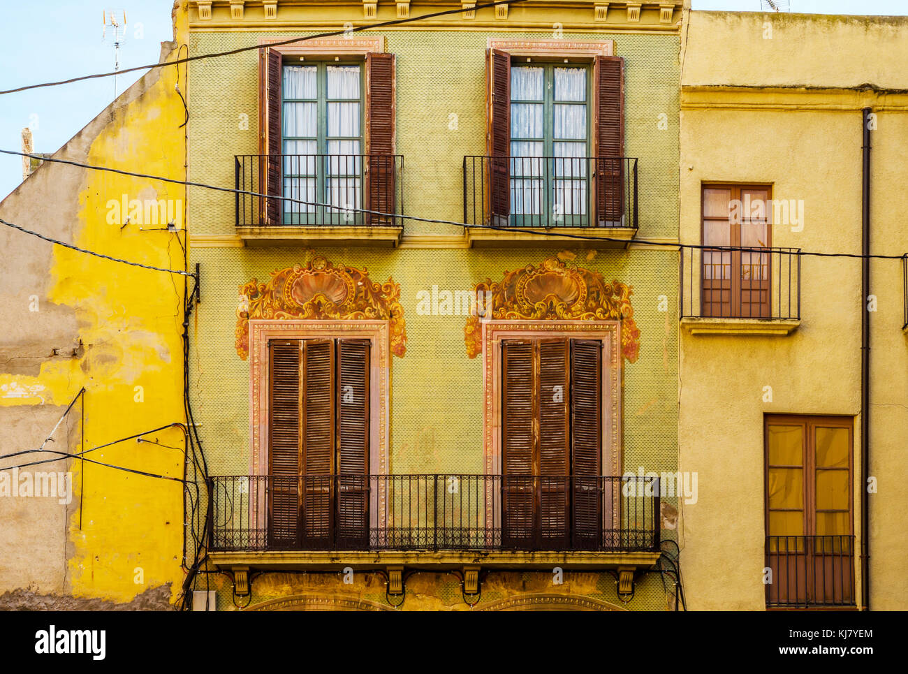 Stylish balcony with a metal railing, solid architectural element, a ...