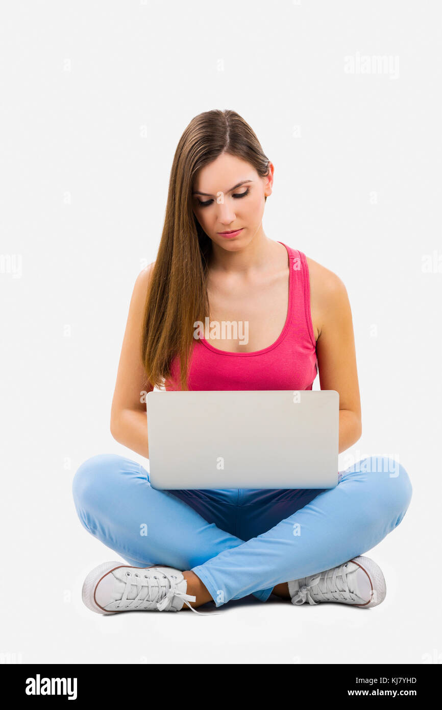 Beautiful woman sitting with crossed legs working with a laptop Stock ...