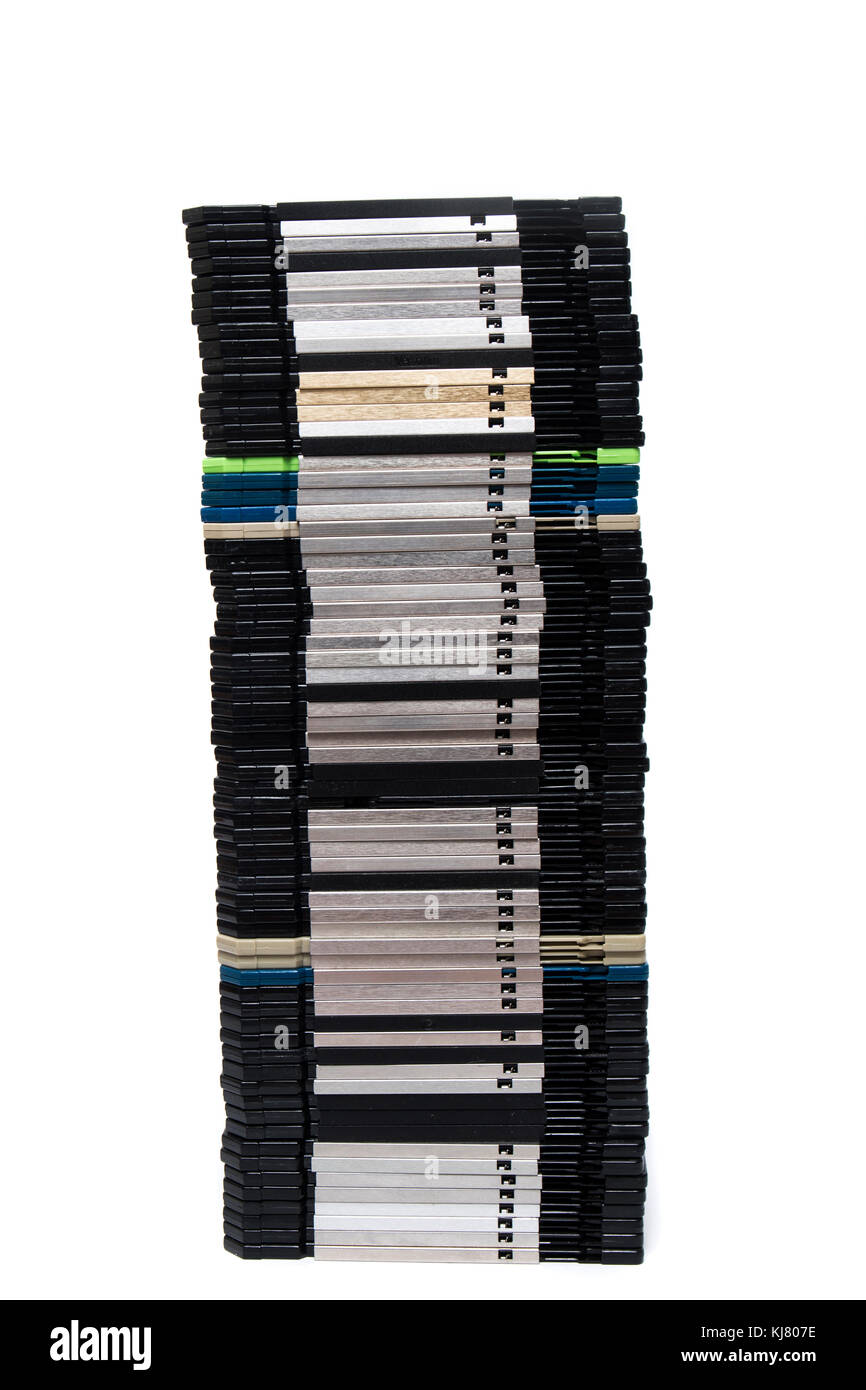 Vertical pile of computer floppy disks isolated on a white background ...