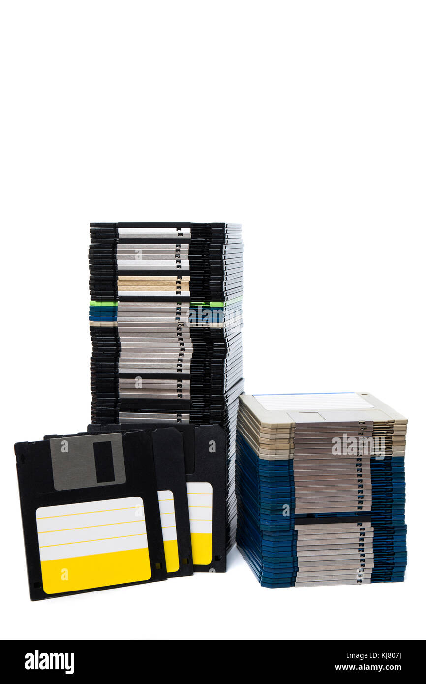 Vertical pile of computer floppy disks isolated on a white background ...